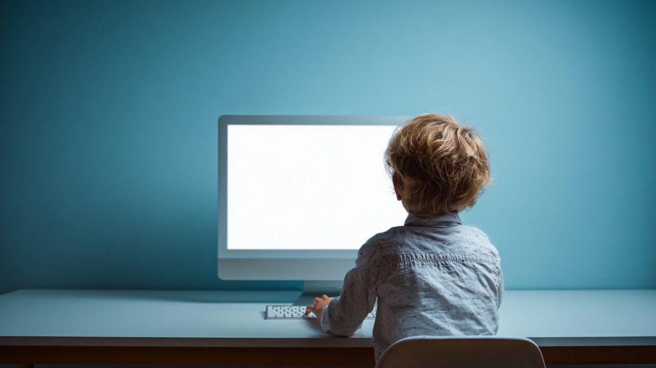 Young Boy Using Desktop Computer – Modern Minimalist Workspace ...
