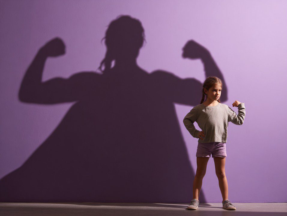 Girl Flexing Muscles with Superhero Shadow – Confidence & Strength ...