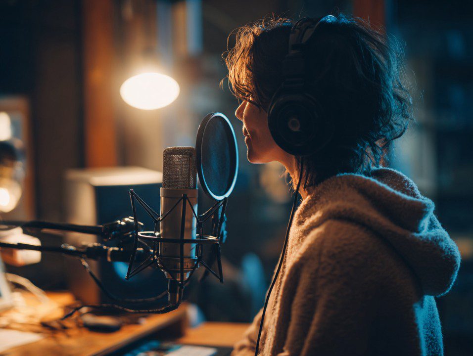 Person Recording a Podcast in Professional Studio - PresentationGO